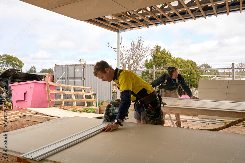 Tradies at worksite cutting cladding boards Stock Photo | Adobe Stock