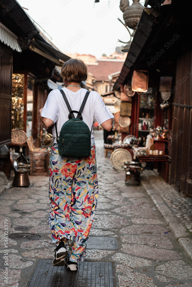 Following a tourist guide and tourist in ancient traditional market ...