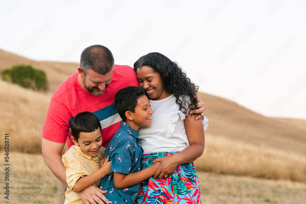 Multiracial family with children hugging portrait Stock Photo | Adobe Stock