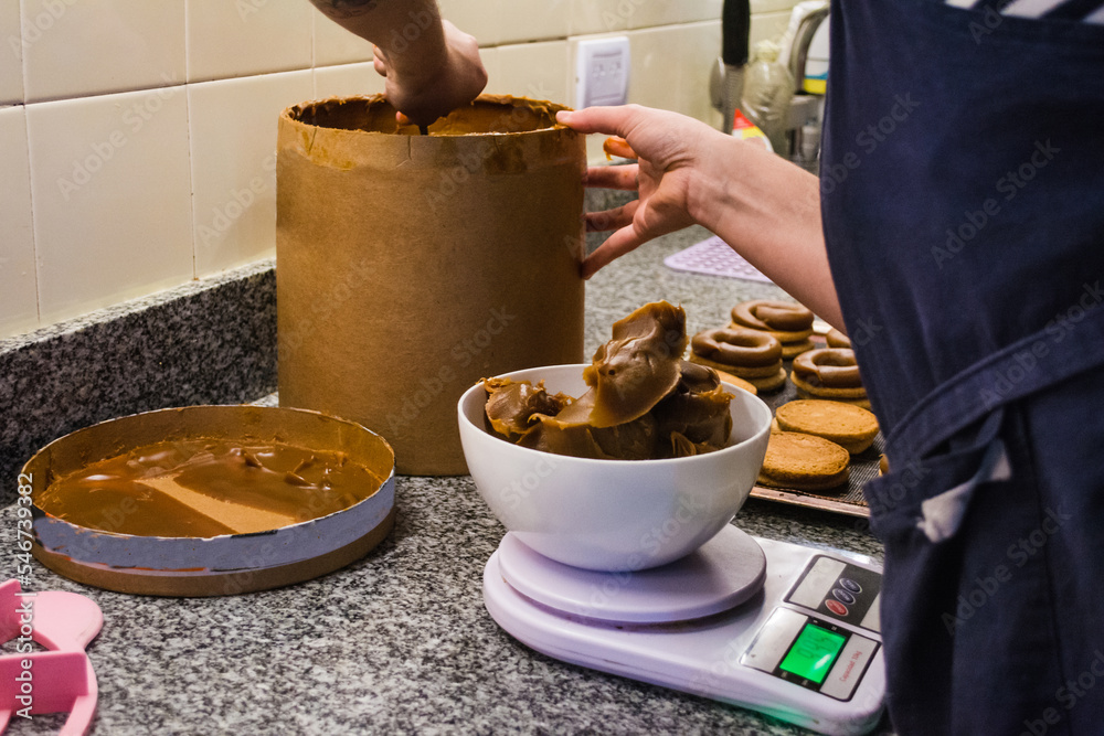 Pastry baker measuring dulce de leche Stock Photo | Adobe Stock