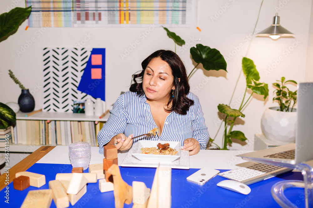 Female having dinner at work office Stock Photo | Adobe Stock