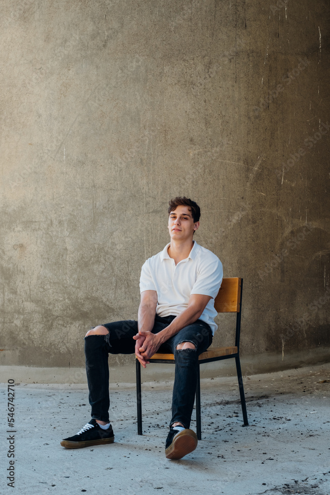 Cool Young Male Model Sitting on Chair Stock Photo | Adobe Stock