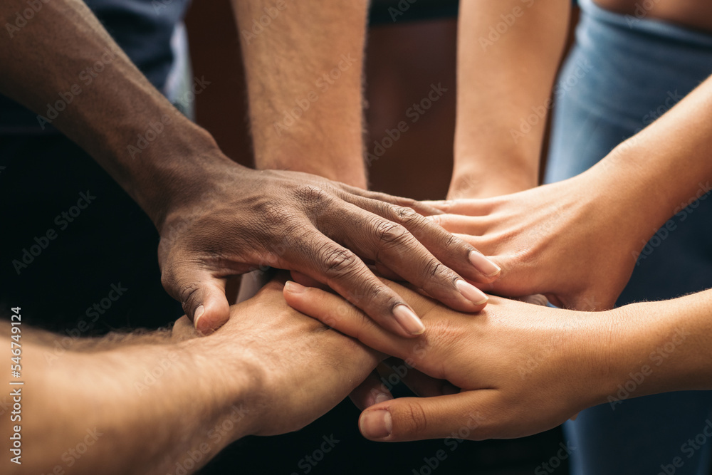 team putting hands together training in the gym Stock Photo | Adobe Stock