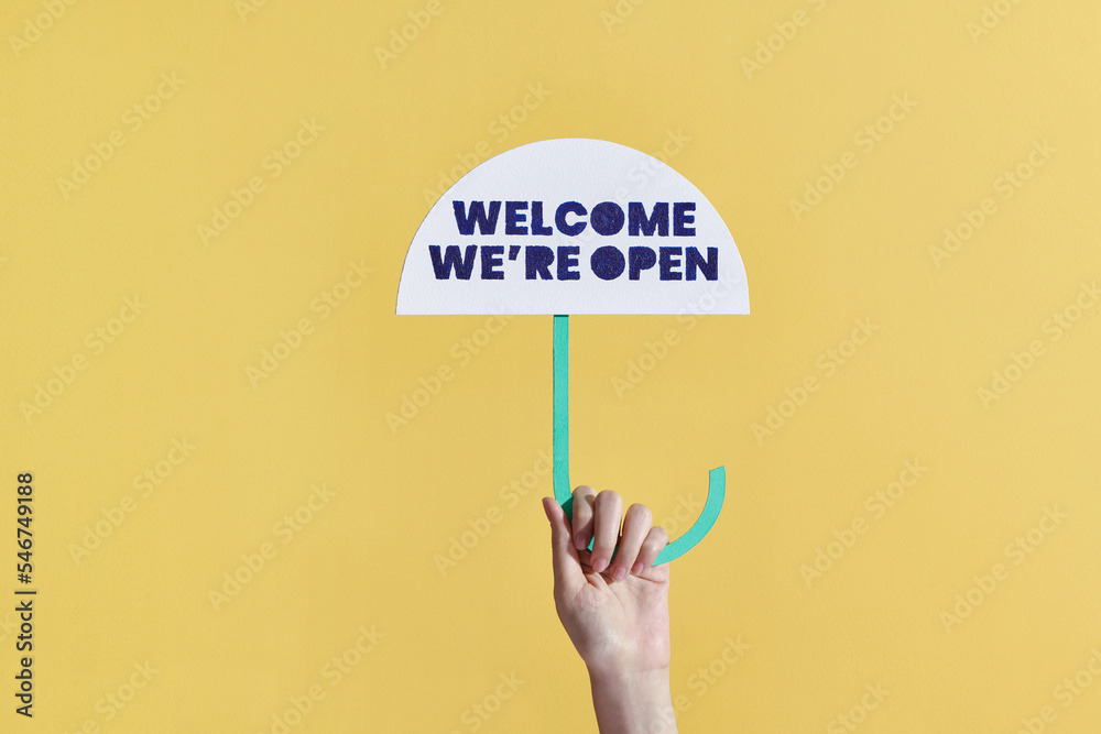 "Welcome We're Open" on cafe or restaurant hang on door at entrance ...
