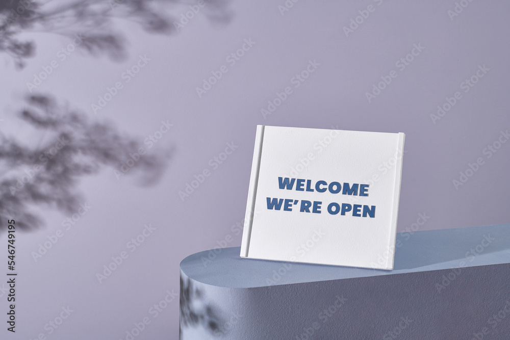 Welcome we're open written on a whiteboard Stock Photo | Adobe Stock