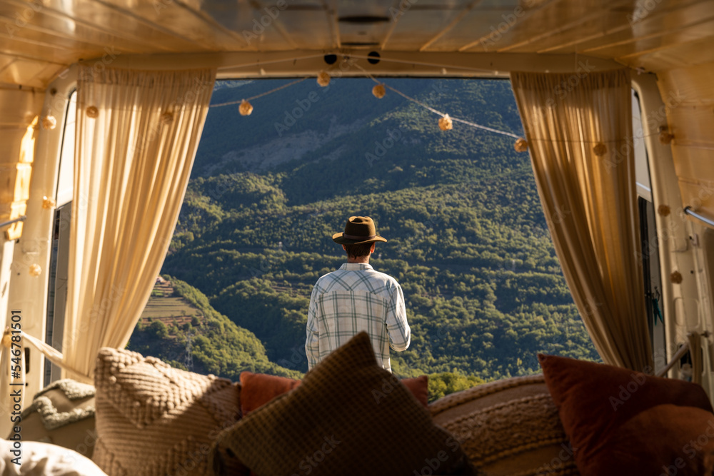 Back view of man in camper van in nature Stock Photo | Adobe Stock