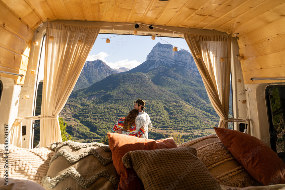 Hugging couple with camper van in nature Stock Photo | Adobe Stock