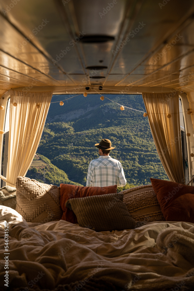 Back view of man in camper van in nature Stock Photo | Adobe Stock
