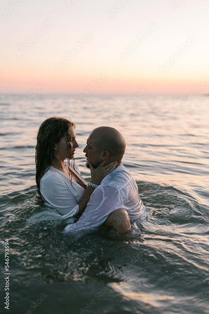 Two young people swimming with their clothes on hugging and kiss Stock ...