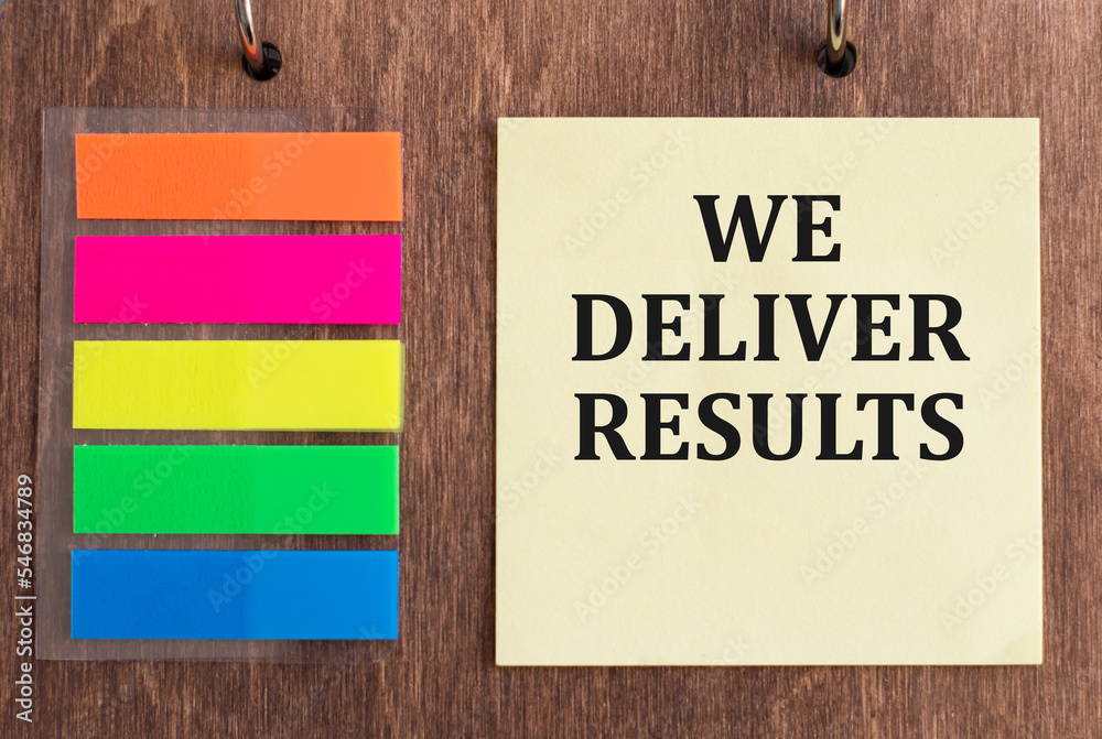 WE DELIVER RESULTS Text written on the notepad with office Stock Photo ...