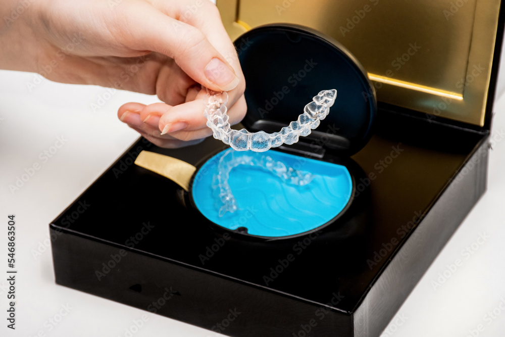 Transparent teeth aligners in a box. Invisible braces. Clear teeth ...