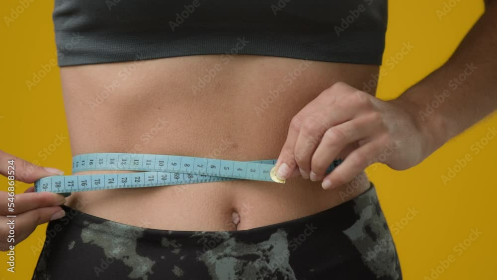 Unrecognizable girl woman measure waist size figure body shape with ...