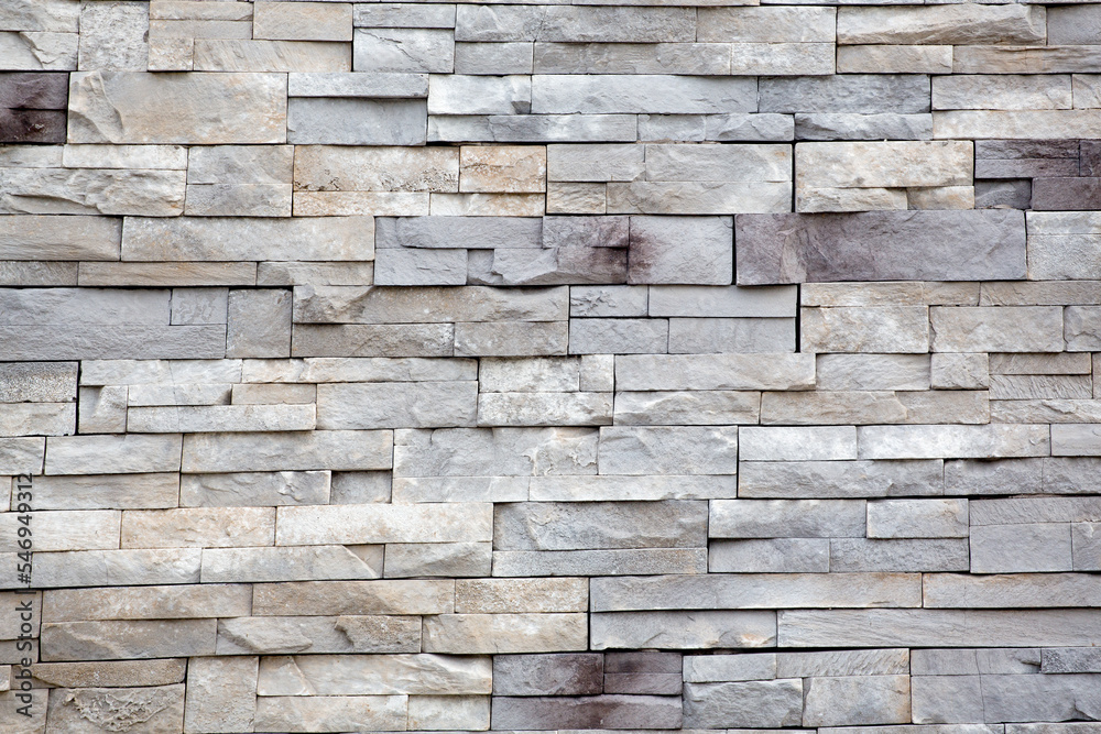 Rows of gray and white cut stone blocks for an exterior wall. Stock ...