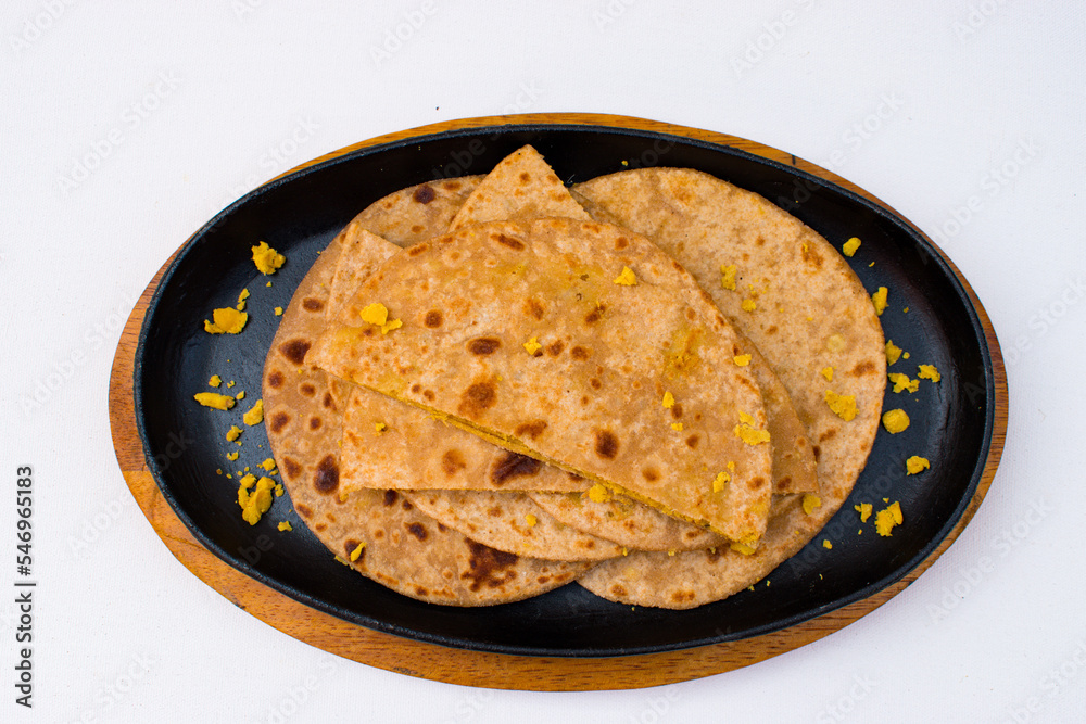 Dal paratha or chana dal stuffed paratha in black plate in white ...