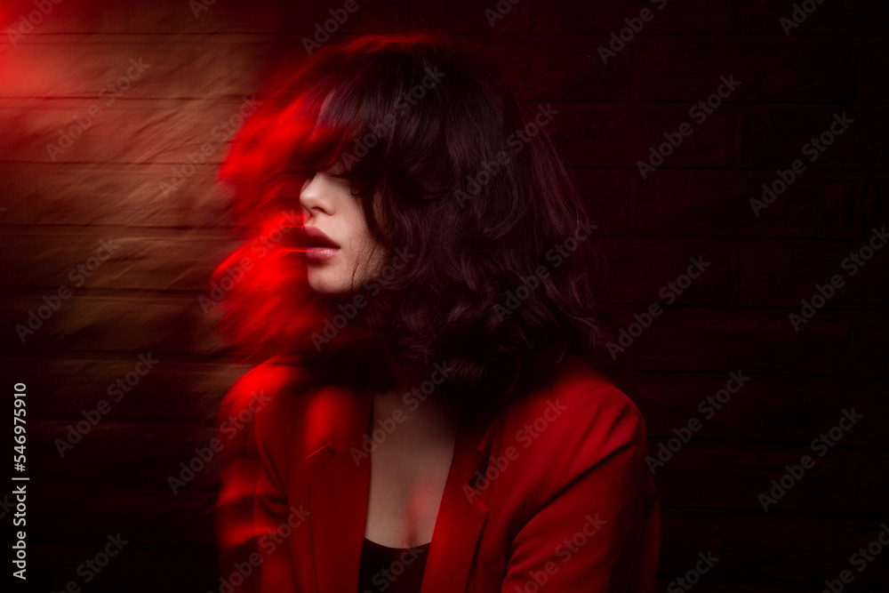 Fashion image of young woman with makeup and hairstyle, wear red suit ...