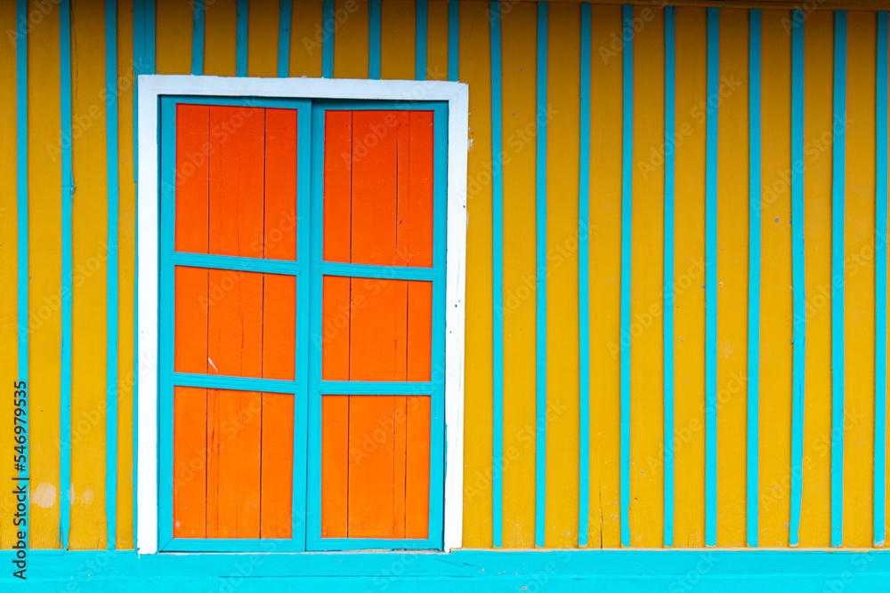 dors and windos decorete the wooden walls of a characteristic little ...