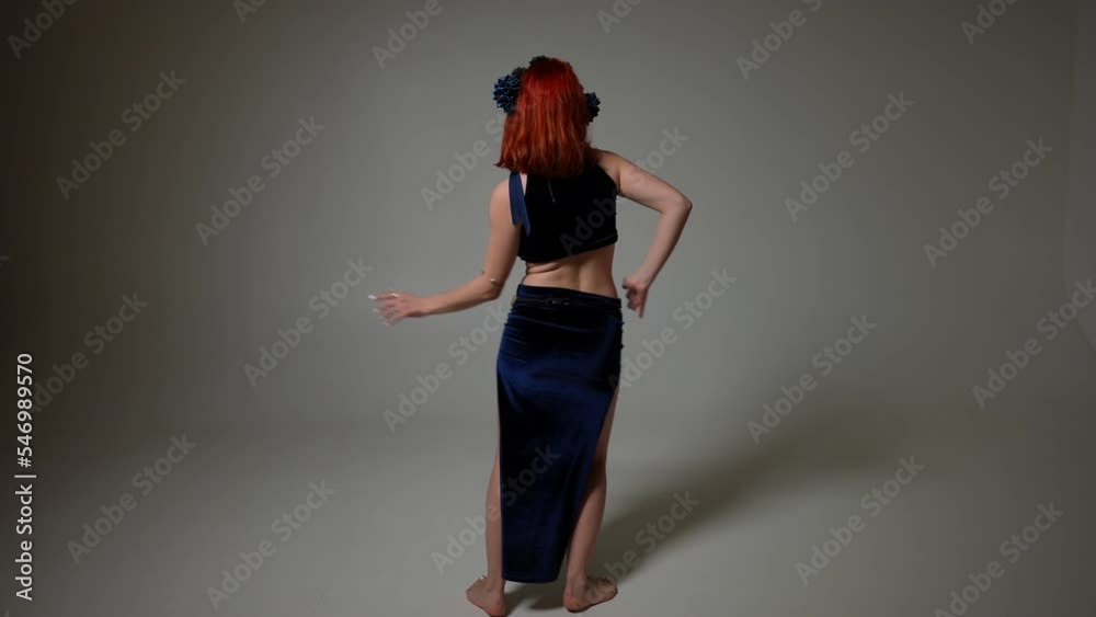 Barefoot slim woman turning dancing Middle Eastern dance in slow motion ...