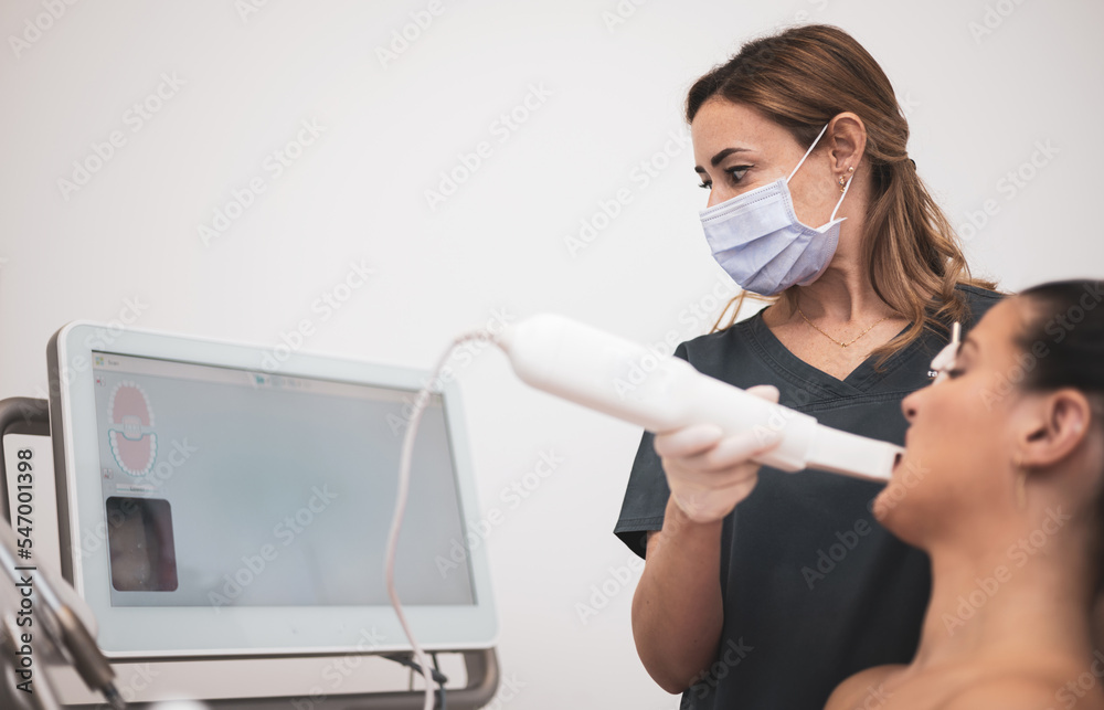 A woman Dentist scanning a patient's teeth with 3d dental scanner ...