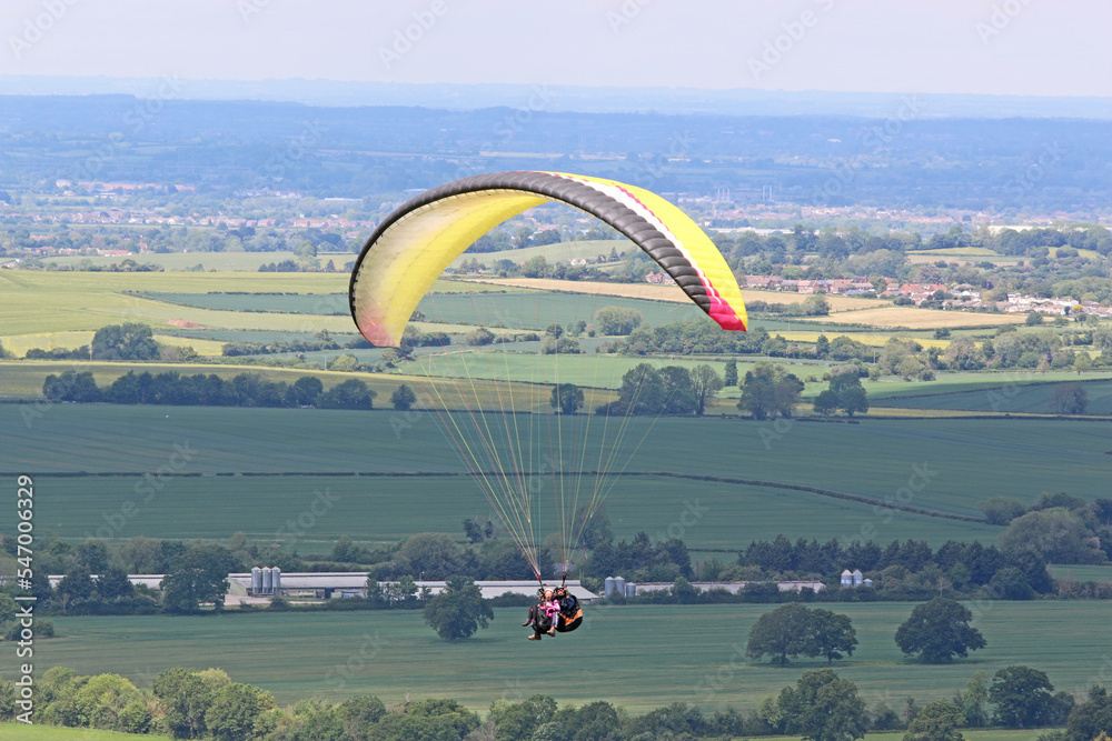 Tandem Paraglider flying from Combe Gibbet, England Stock Photo | Adobe ...