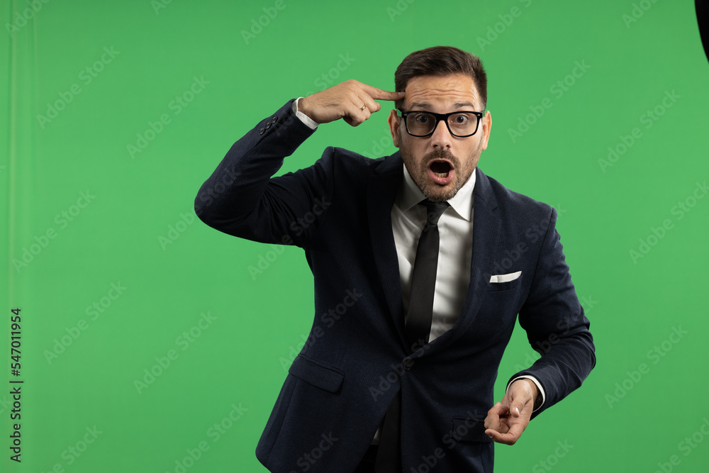 Young business man dressed in formal suit acting angry, and worried ...