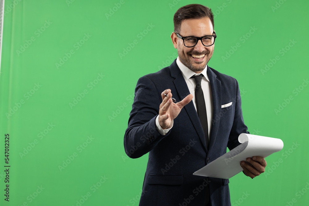 Picutre of a young business man, formal dressed in suit, taking notes ...
