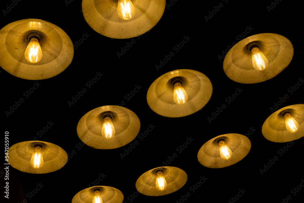 Hanging line of antique and vintage lamps. Series of old light bulbs in ...