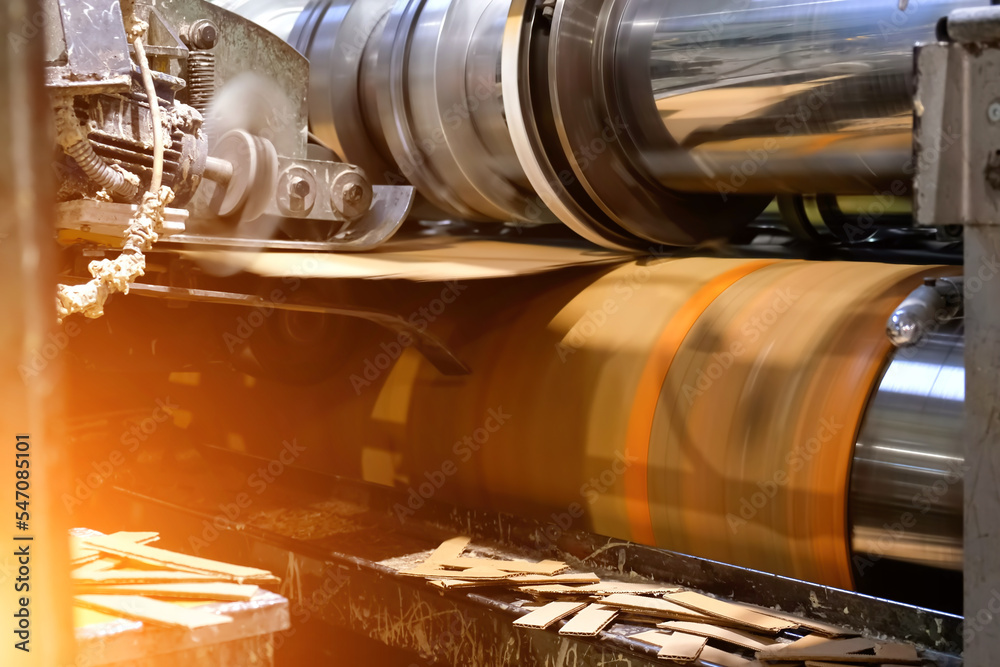 Ready-made cardboard boxes are moved in stacks along an automated ...