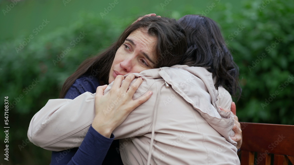 Sad woman suffering from negative emotion. Two women embracing each ...