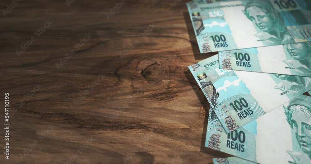 Brazilian Real 100 BRL banknotes on the wooden table. Brazil currency ...