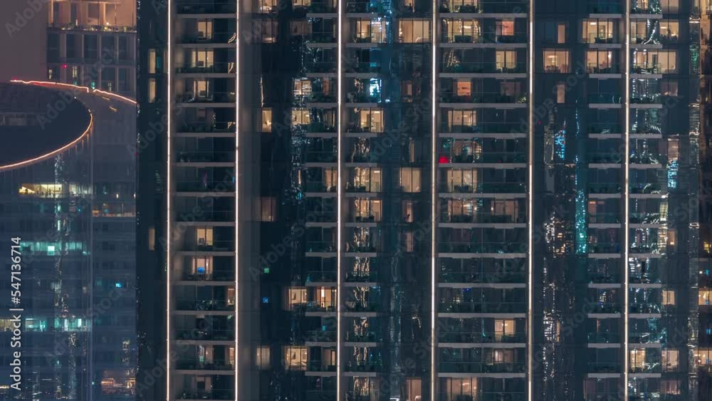 Windows in high-rise hotel building exterior in the late evening with ...