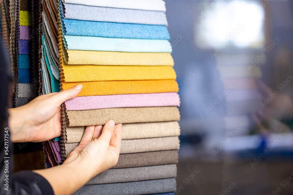 Fabric swatches in different colors are stacked for selection. The ...