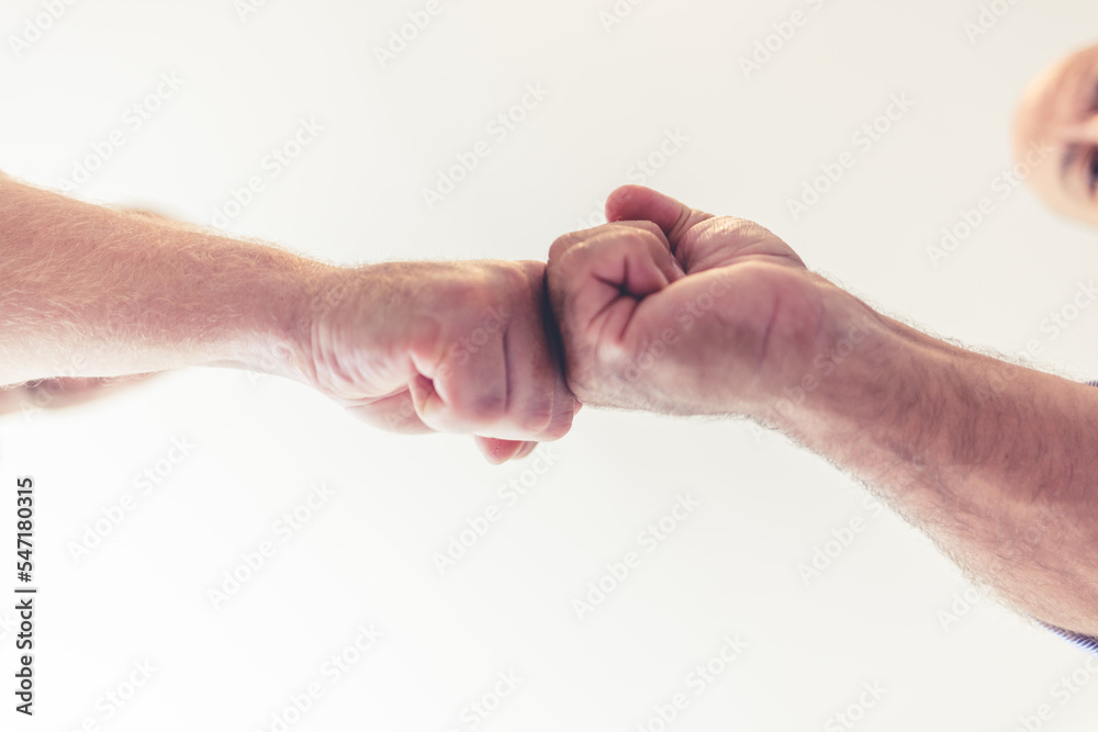 Shot of two unrecognizable businesspeople giving a fist bump outside ...