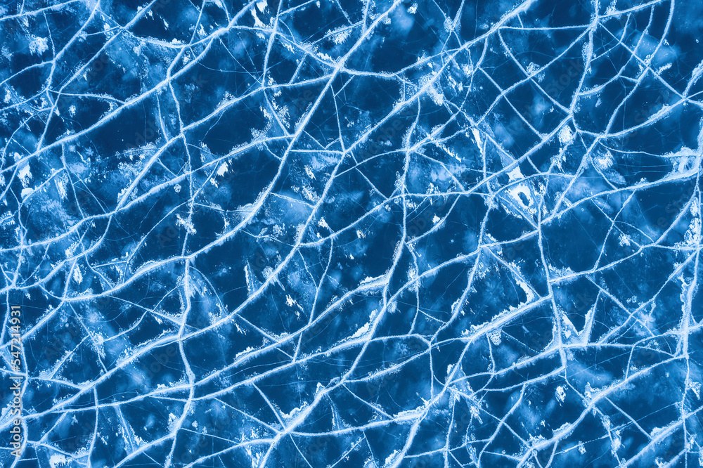 Ice on a frozen river. Background texture of blue ice with cracks in the snow. drone view. Stock ...