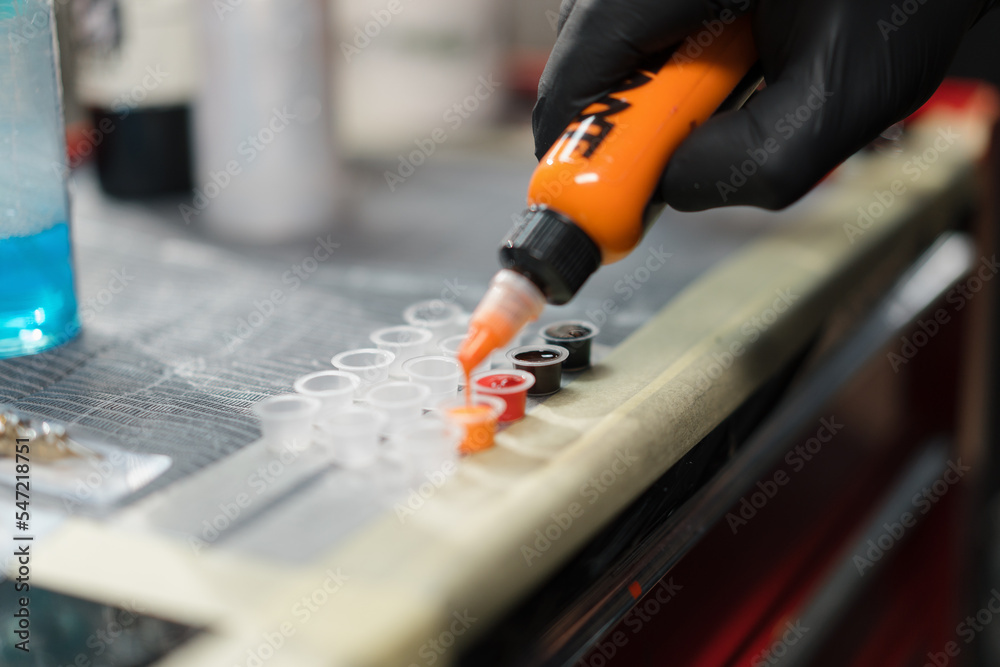 The process of pouring tattoo ink into a container, tattoo studio ...