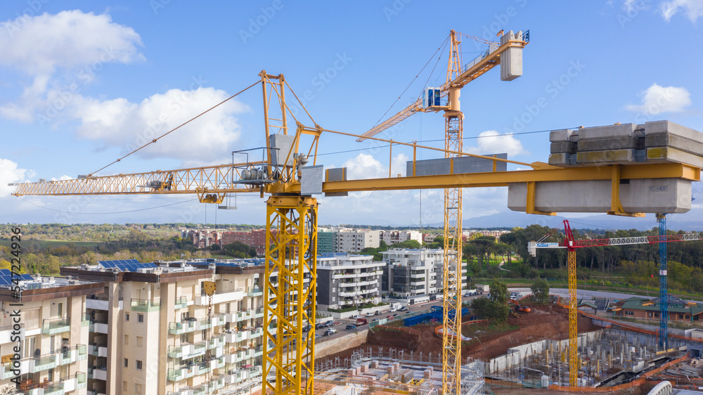 Aerial view of a industrial tower crane operating in high building ...