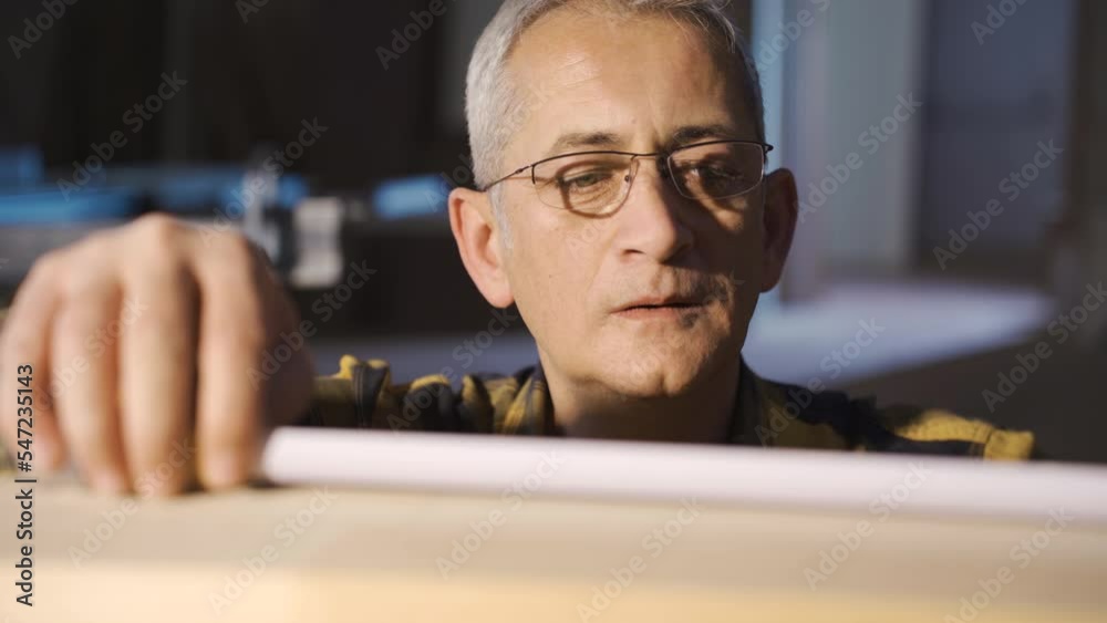 Carpenter master measures wood with meters. Carpenter man measuring ...