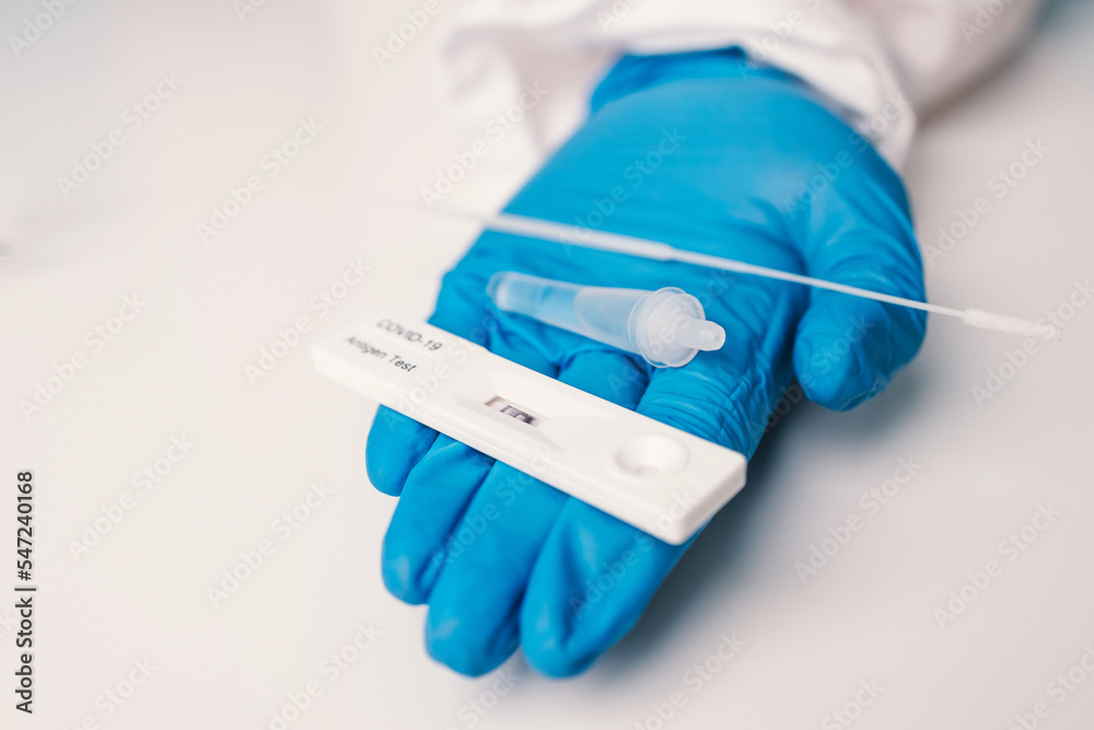A laboratory employee taking sample PCR microtubes with cotton swab ...