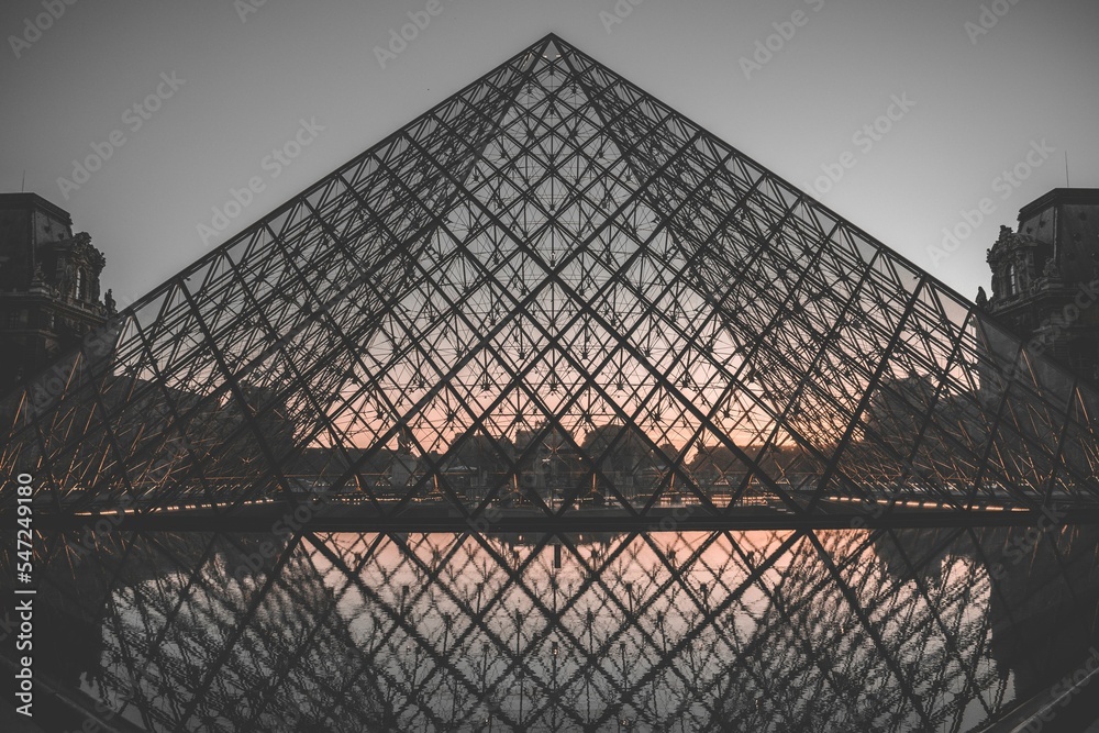 Glass pyramid of museum of Louvre against sunset sky Stock Photo ...