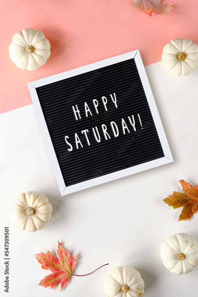 Happy Friday greeting text on text board. Autumn leaves and pumpkins ...