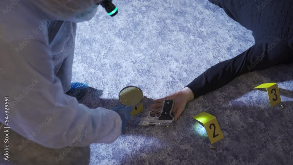 Forensic expert examining the body of the man who committed suicide ...