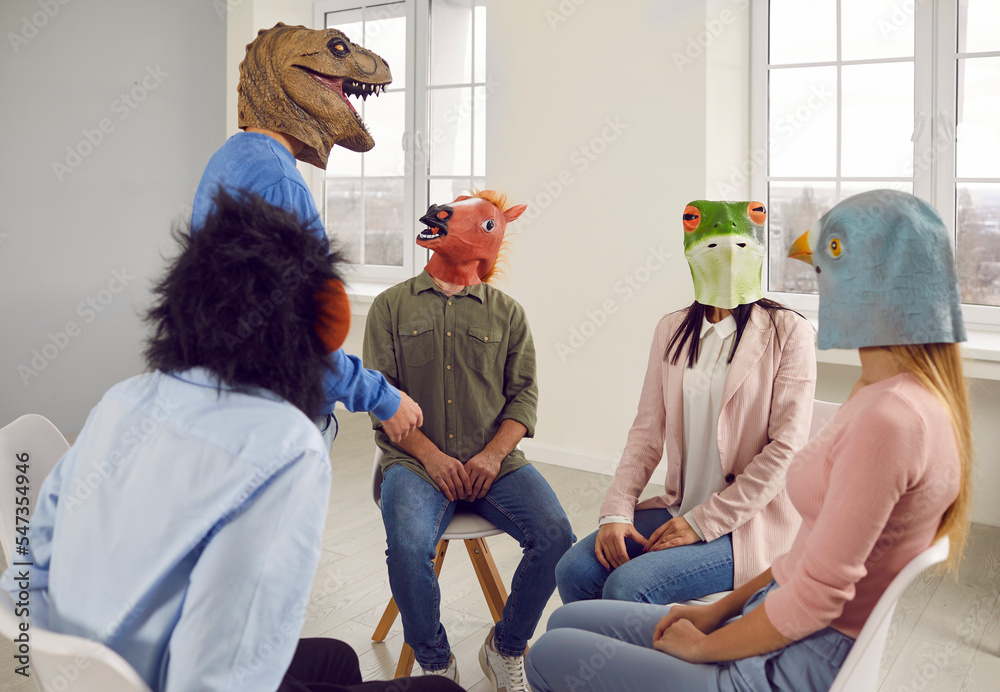 People wearing strange animal masks talking during a group therapy ...