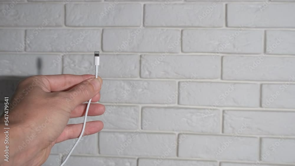 Various sockets and connectors for charging gadgets. Male hands choose ...