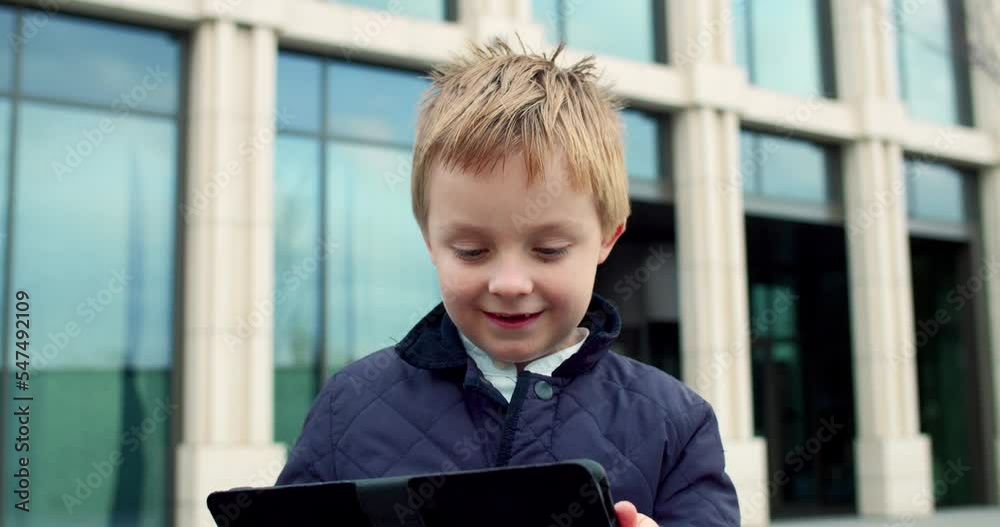 Vidéo Stock Close-up portrait of cute little happy joyful boy playing ...