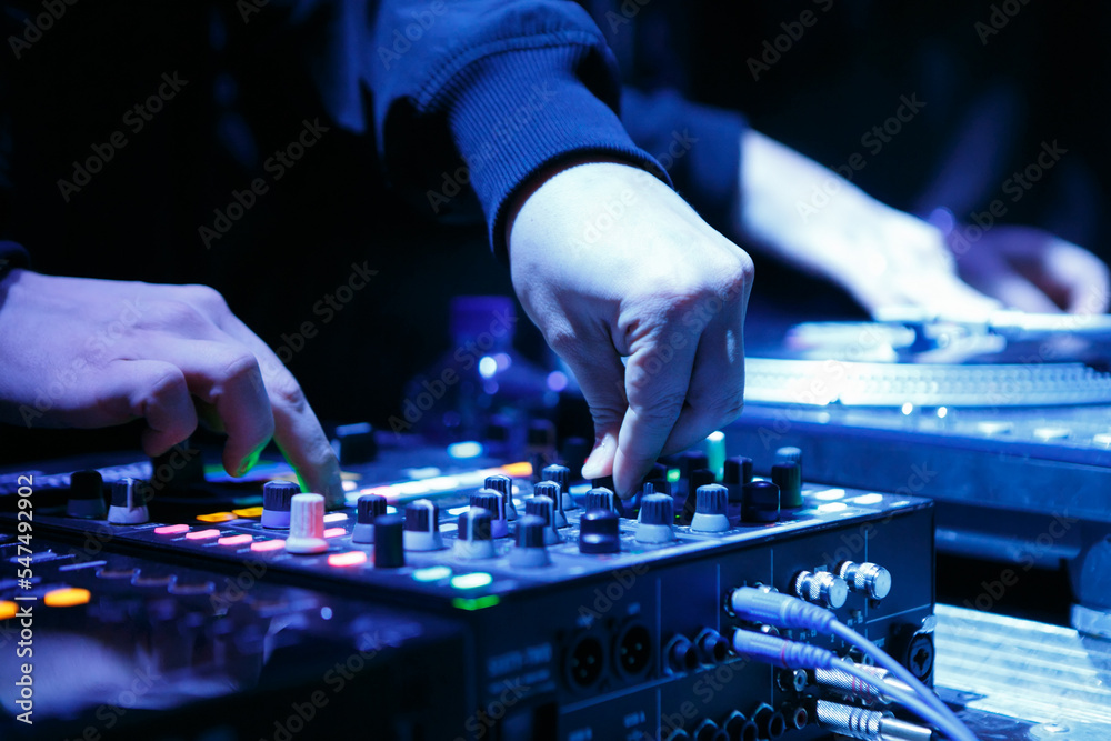 Dj playing music on party in night club. Professional disc jockey ...