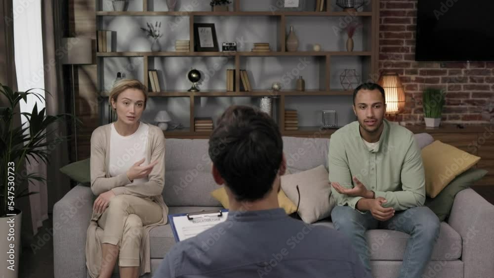 Multiracial quarrel between husband and wife at a session with a ...