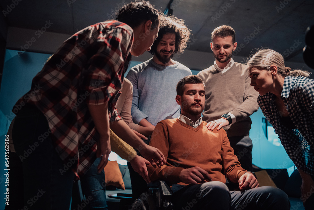 Colleagues help their friend in a wheelchair to take his first steps in ...