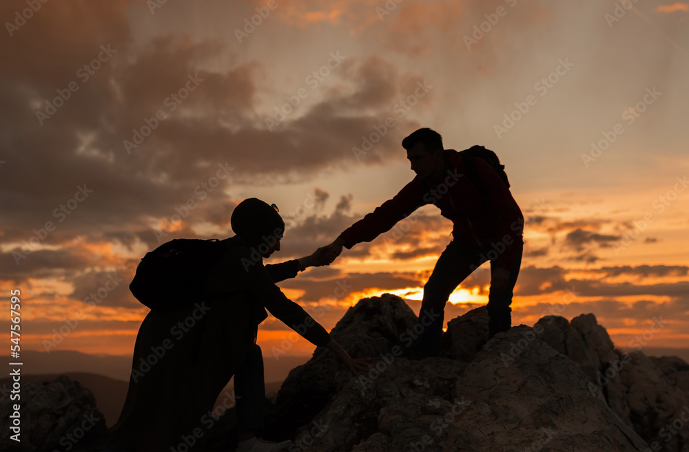 Hiking team helping each other friend giving a helping hand while ...