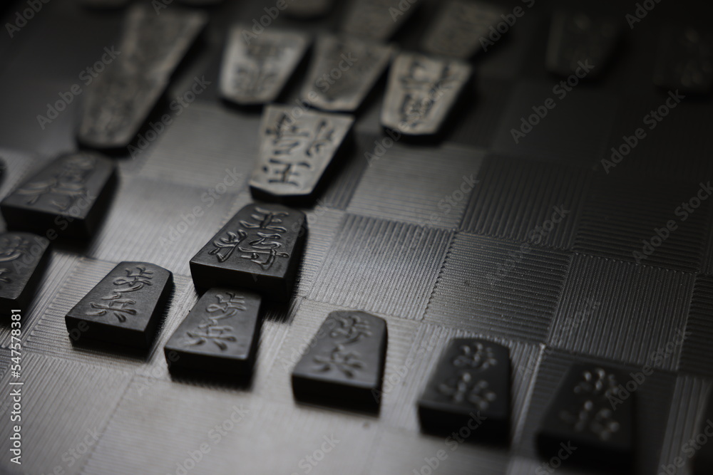 Foto de Piece of Shogi (made of titanium) on titanium plate. Shogi is ...