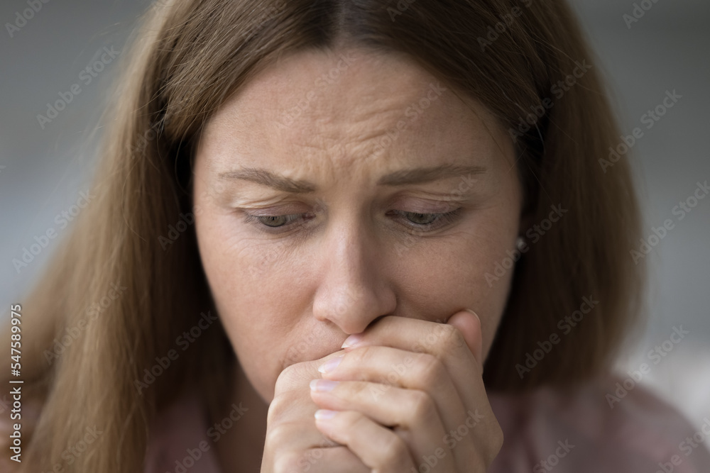 Sad young woman sit indoors thinks about problems and life troubles ...