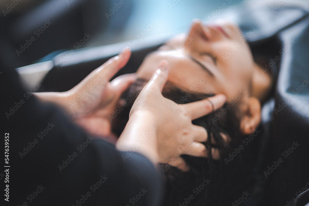 young beautiful woman client getting hair treatment in beauty salon ...